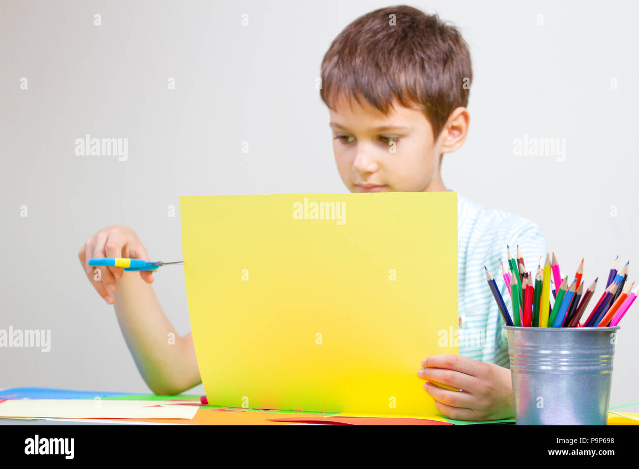 Elementary boy cutting paper scissors hi-res stock photography and ...