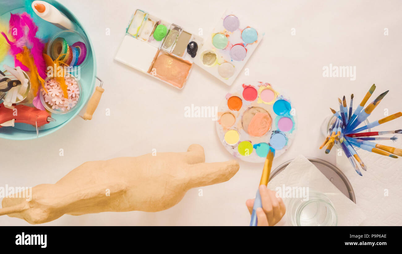 Step by step. Unfinished paper mache unicorn on the table Stock Photo ...