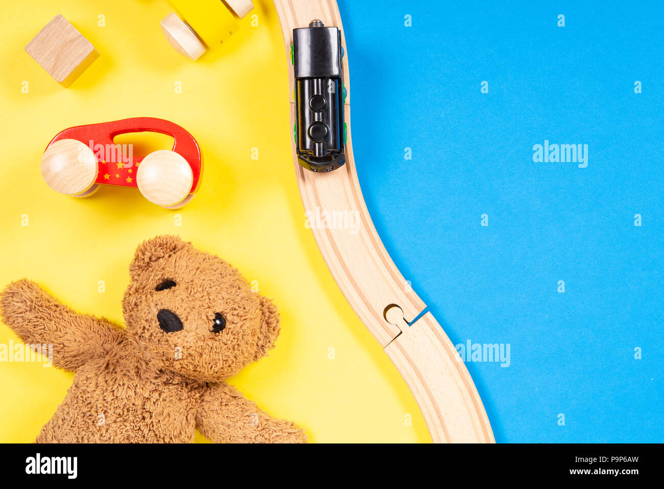 Colorful toys background with teddy bear, toy train, wooden cars and ...