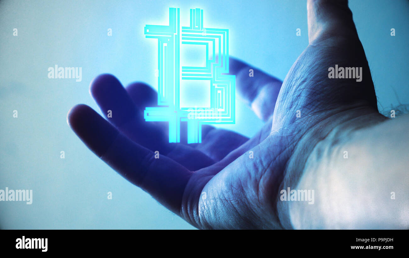 the virtual currency of a bitcoin in the hand of a business man Stock ...