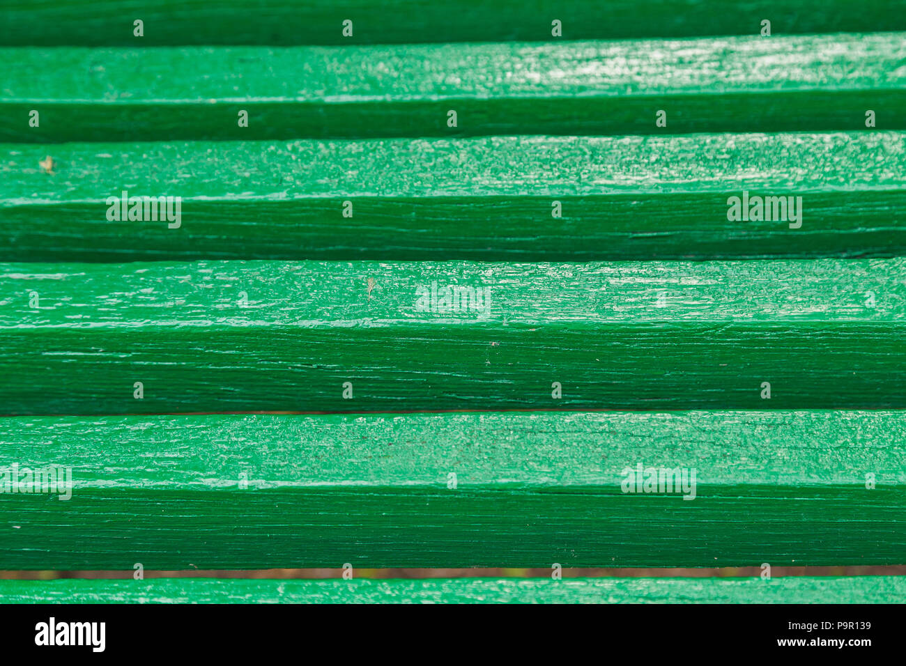 Details of a green bench, background of boards painted in green color ...