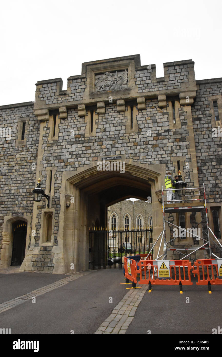 Maintenance workers work on the lamps on St. George's Gateway at ...