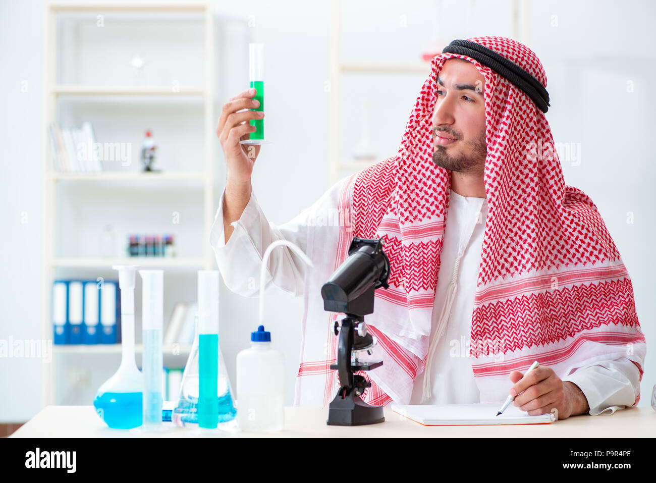Arab chemist working in the lab office Stock Photo - Alamy