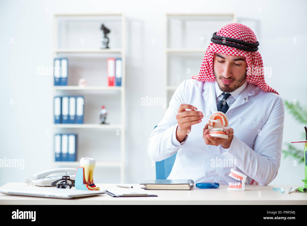 Arab dentist working on new teeth implant Stock Photo - Alamy