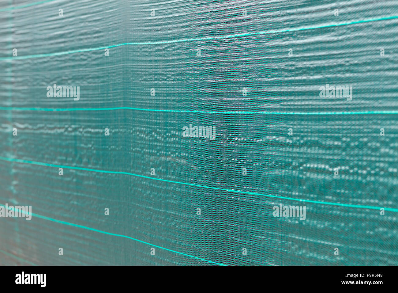 green protective net cloth background. building construction site with ...