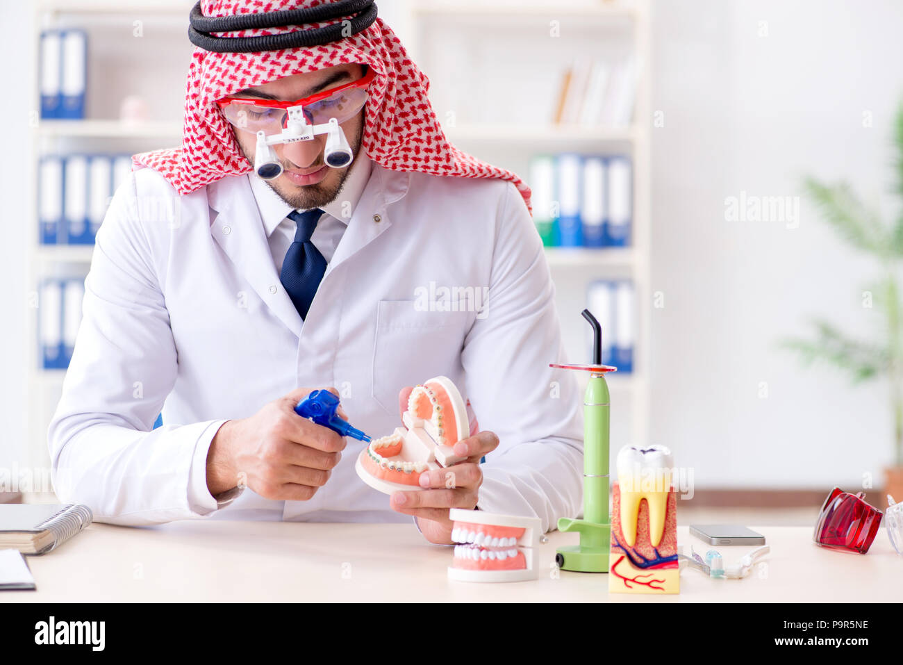Arab dentist working on new teeth implant Stock Photo - Alamy