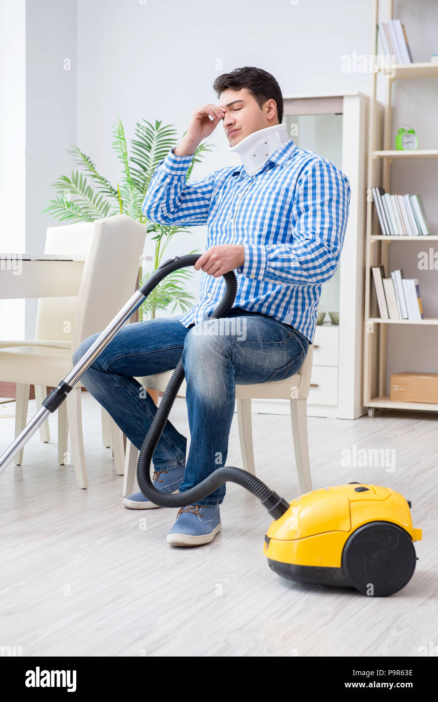 Injured man with neck injury vacuum cleaning house Stock Photo - Alamy