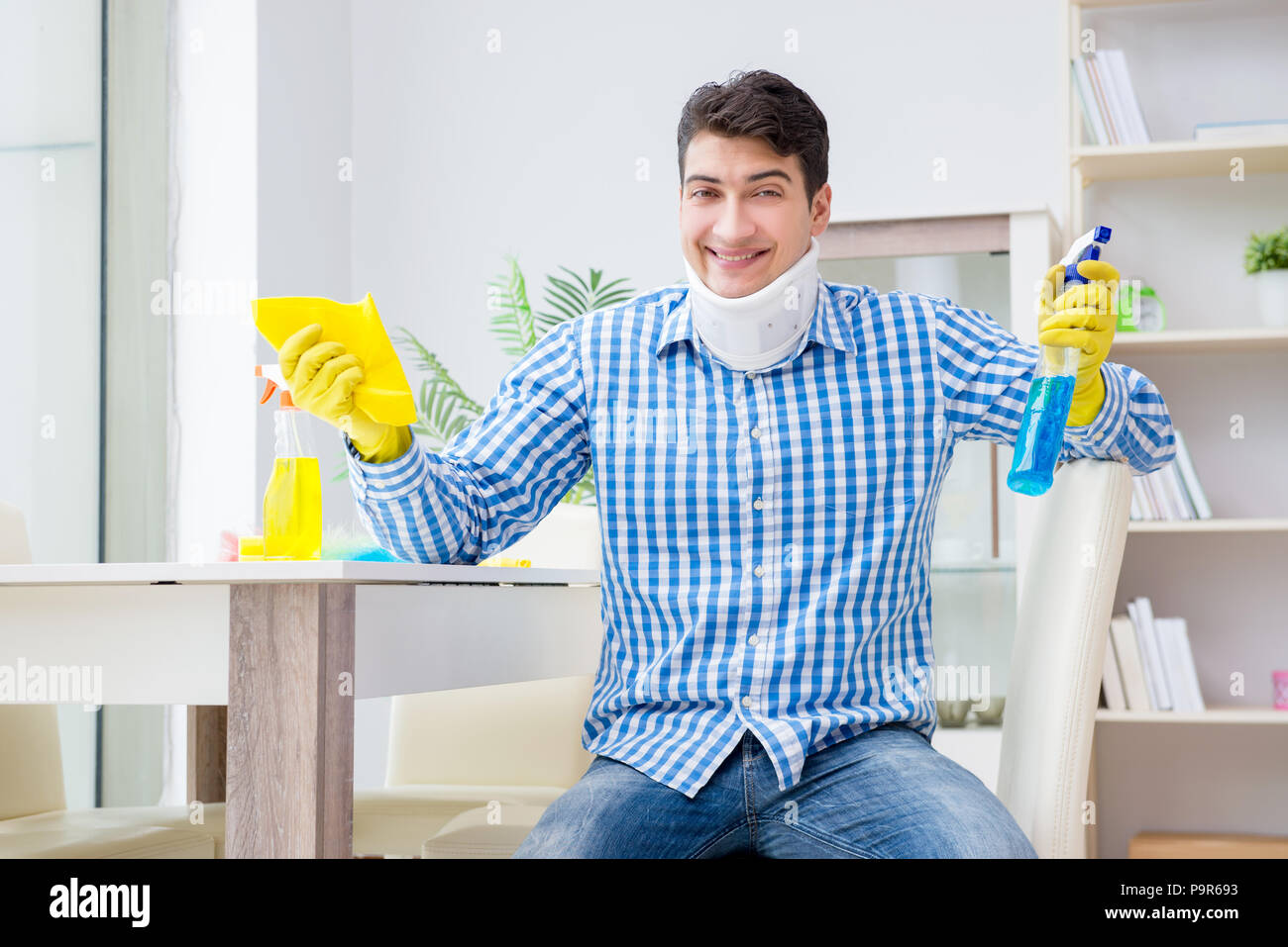 Man with neck unjury cleaning house in housekeeping concept Stock Photo ...