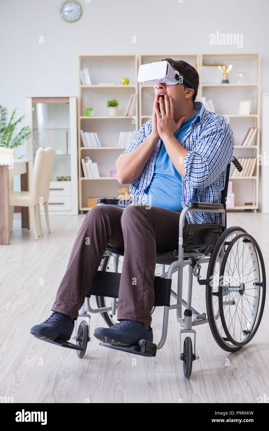 Disabled man studying with virtual reality glasses Stock Photo - Alamy