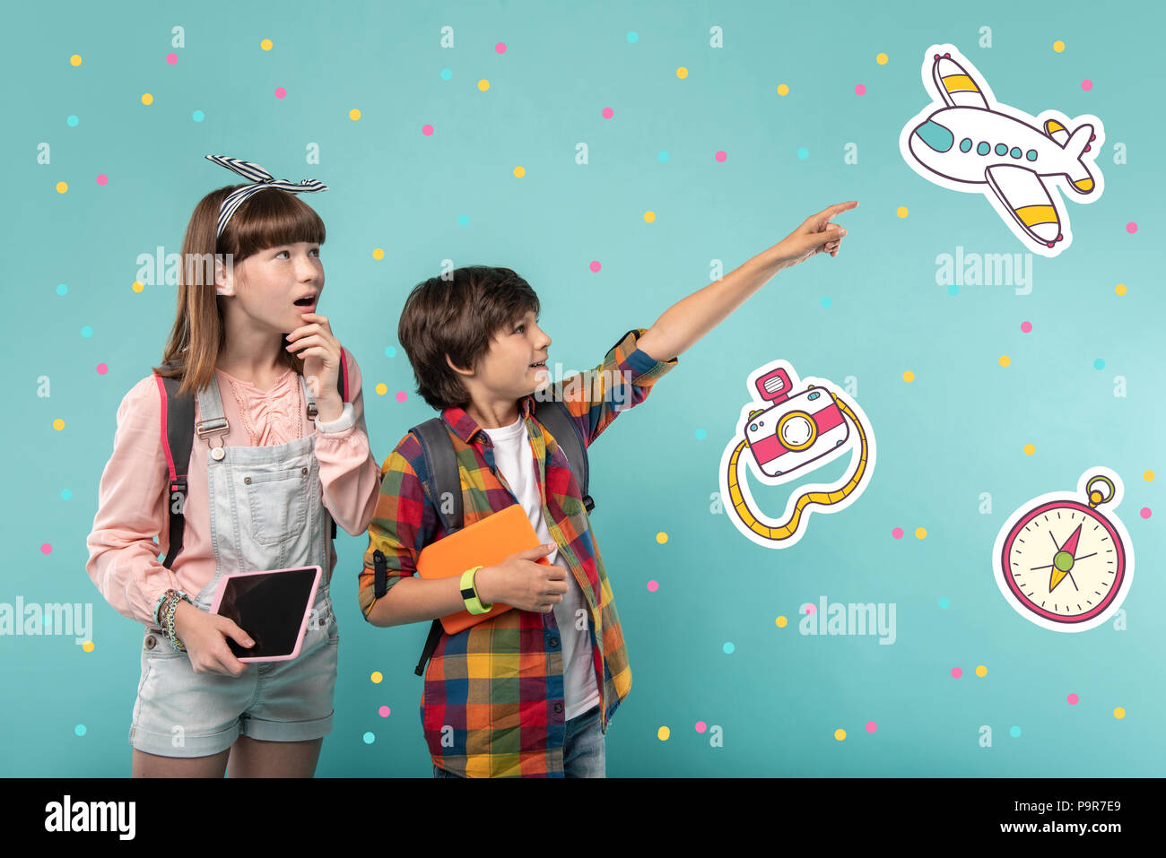 Positive boy pointing to the plane and his friend looking impressed ...