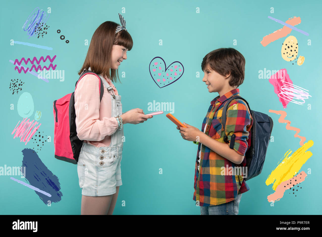 Boy girl exchanging phone hi-res stock photography and images - Alamy