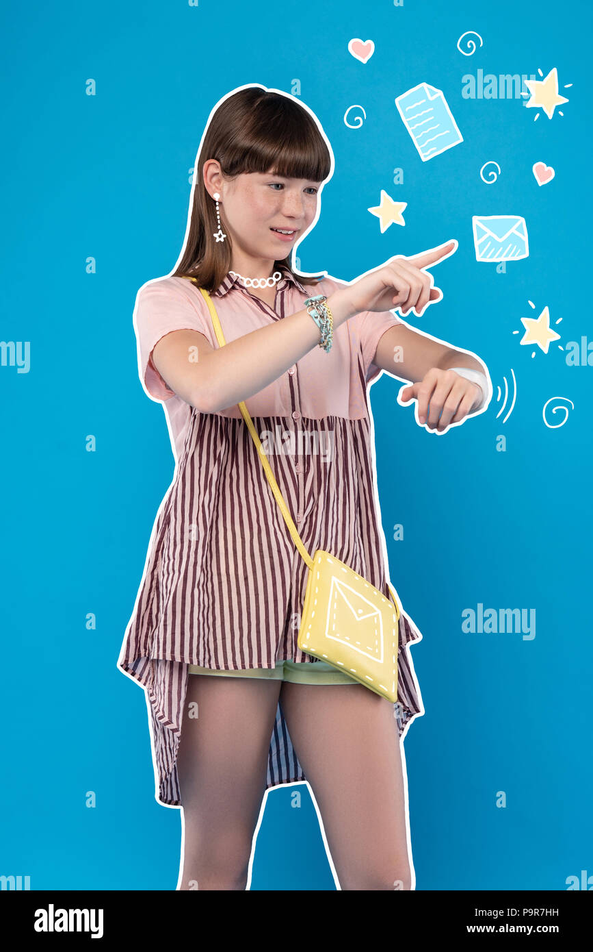 Cute teenager sending messages while having a smart watch Stock Photo ...