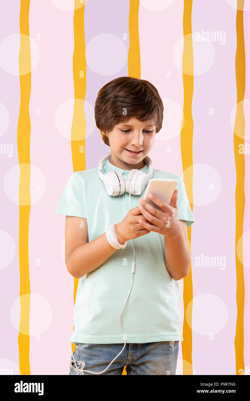 Smiling boy looking at the screen while playing games online Stock ...