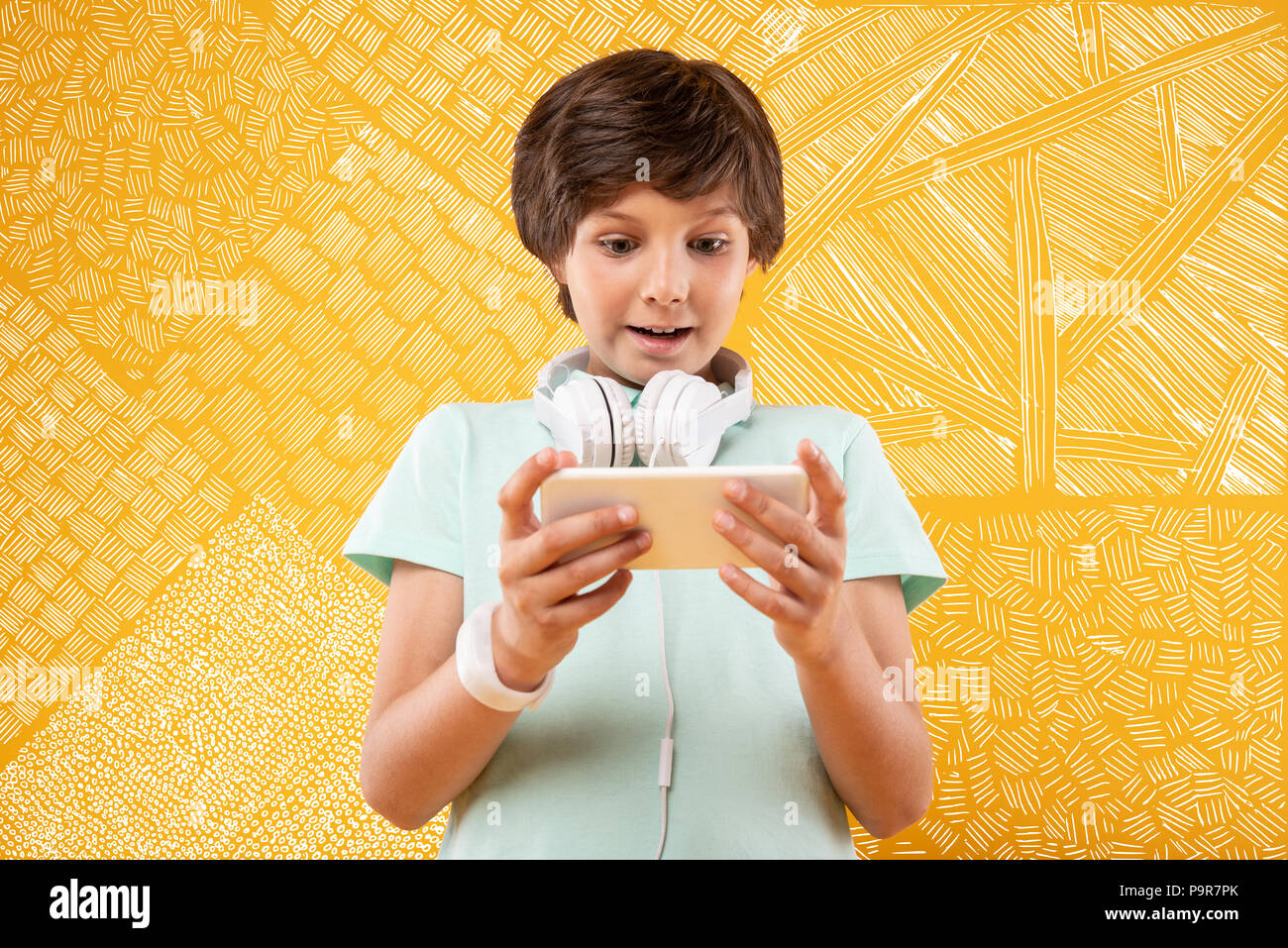Excited boy holding a smartphone when having a video call Stock Photo ...