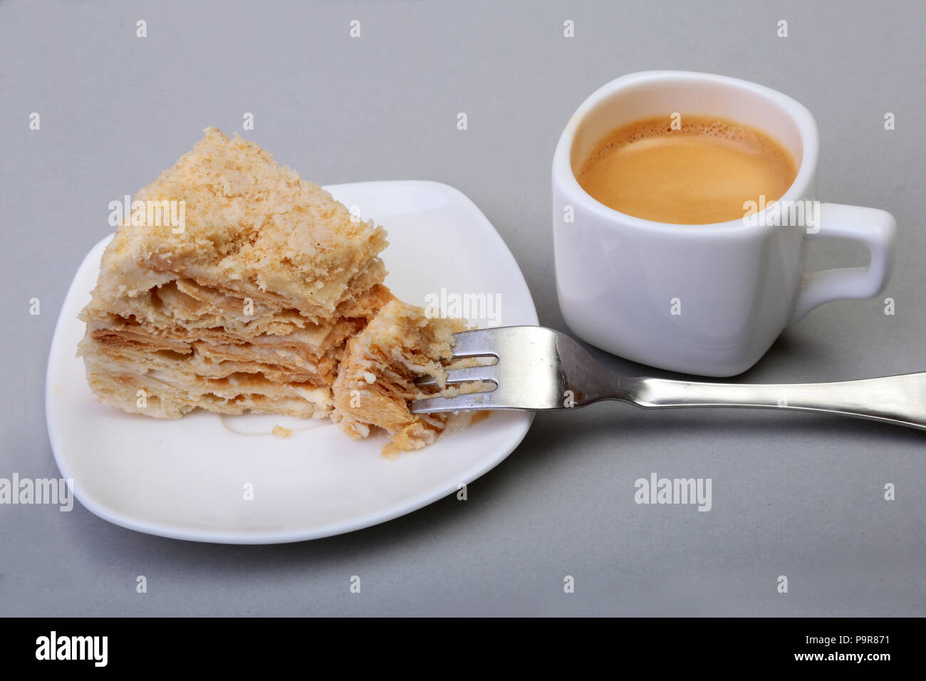 Homemade Napoleon puff cake on plate and traditional espresso coffee ...