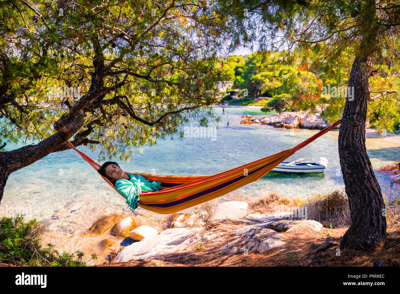 Young Asian who relaxes in the hammock on a tropical beach Stock Photo ...
