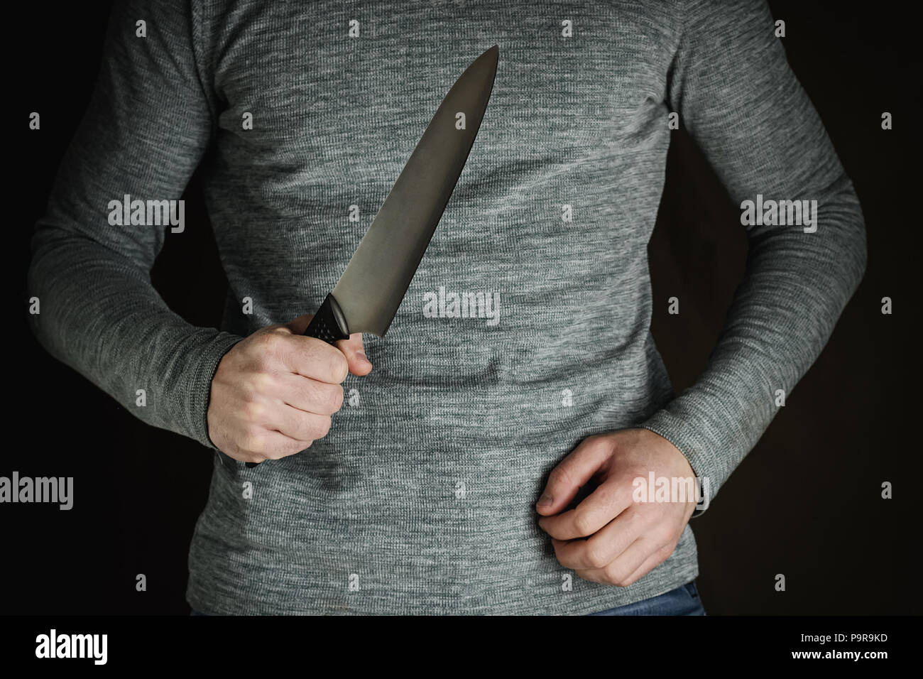 Evil criminal with large sharp knife ready for robbery or to commit a ...