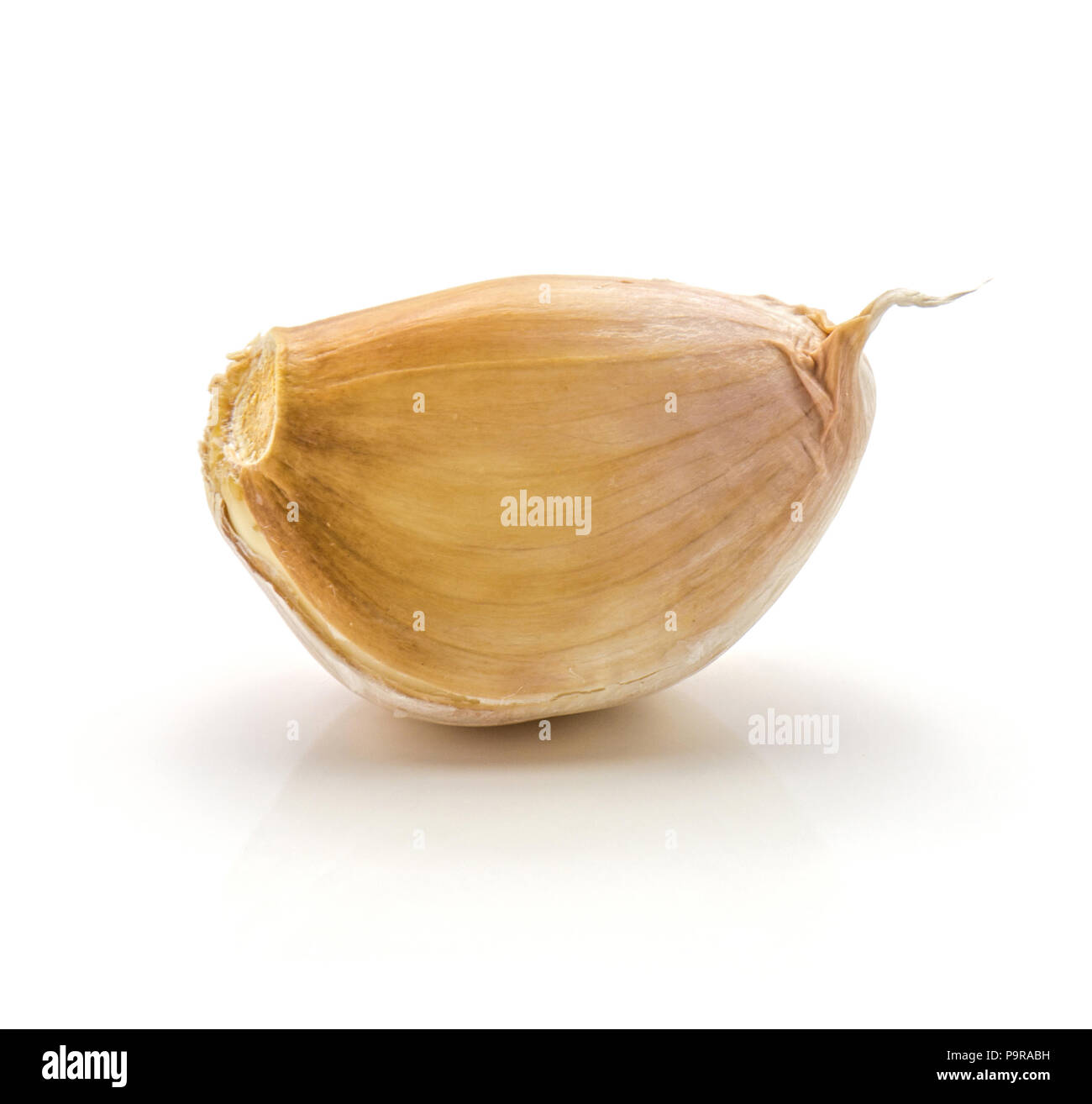 One garlic clove isolated on white background unpeeled Stock Photo - Alamy