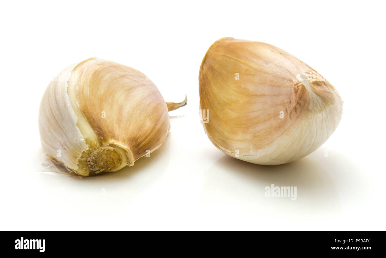 Two garlic cloves isolated on white background Stock Photo - Alamy