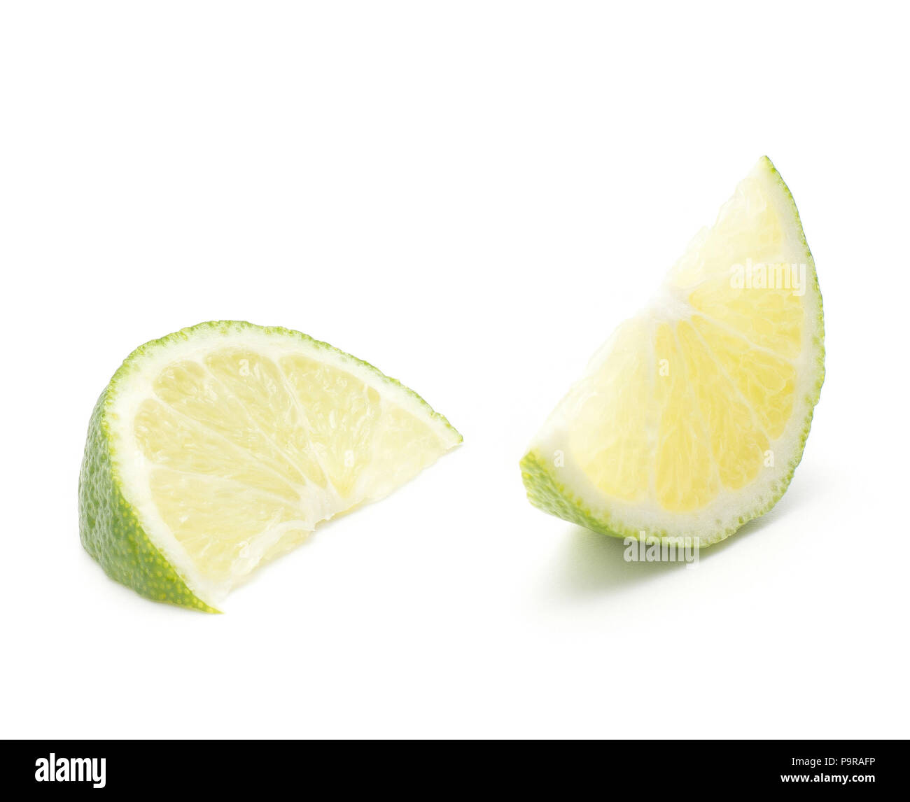 Two separated lime slices isolated on white background Stock Photo - Alamy
