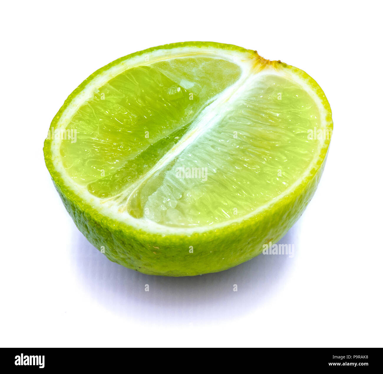 One lime cross section half isolated on white background Stock Photo ...