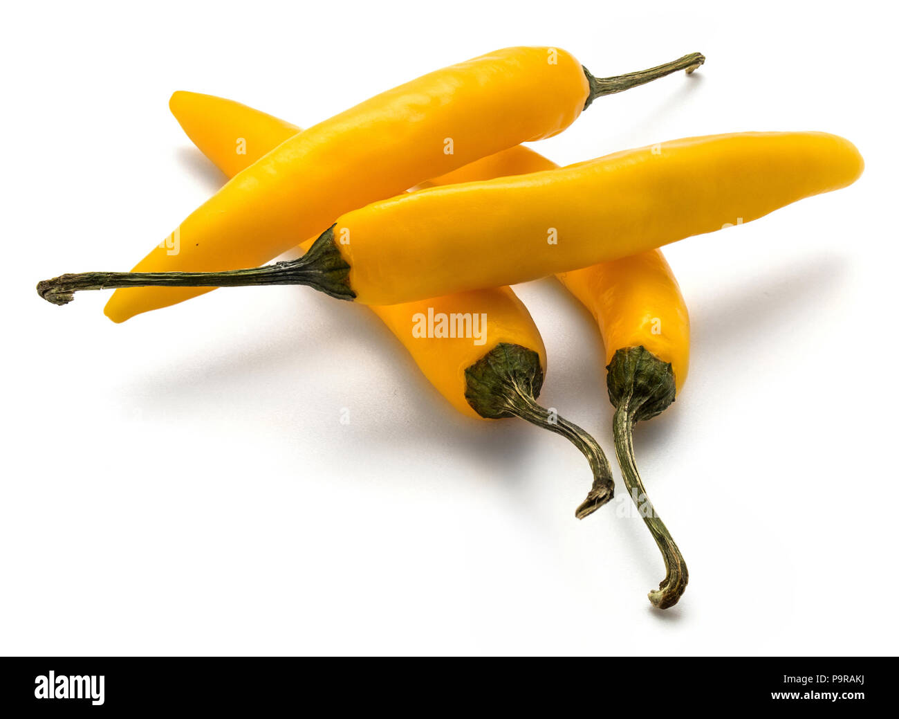 Group of four whole yellow Chili peppers isolated on white background ...