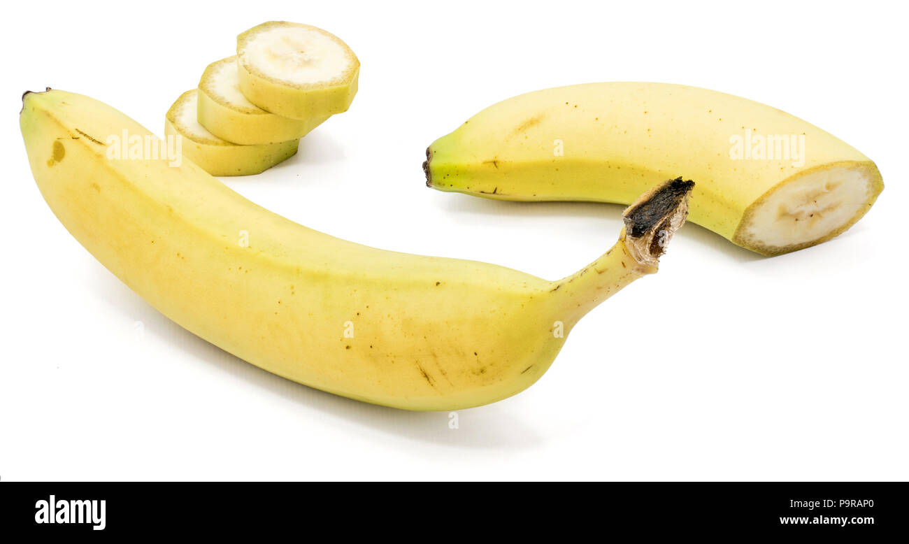 One whole yellow banana, round slices and banana half isolated on white ...