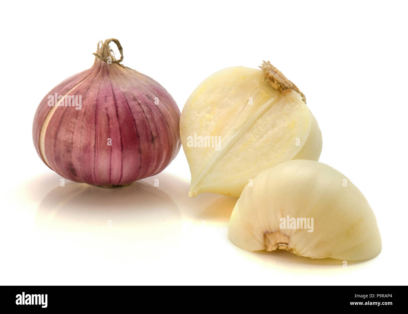 One whole solo garlic and two sliced halves isolated on white ...