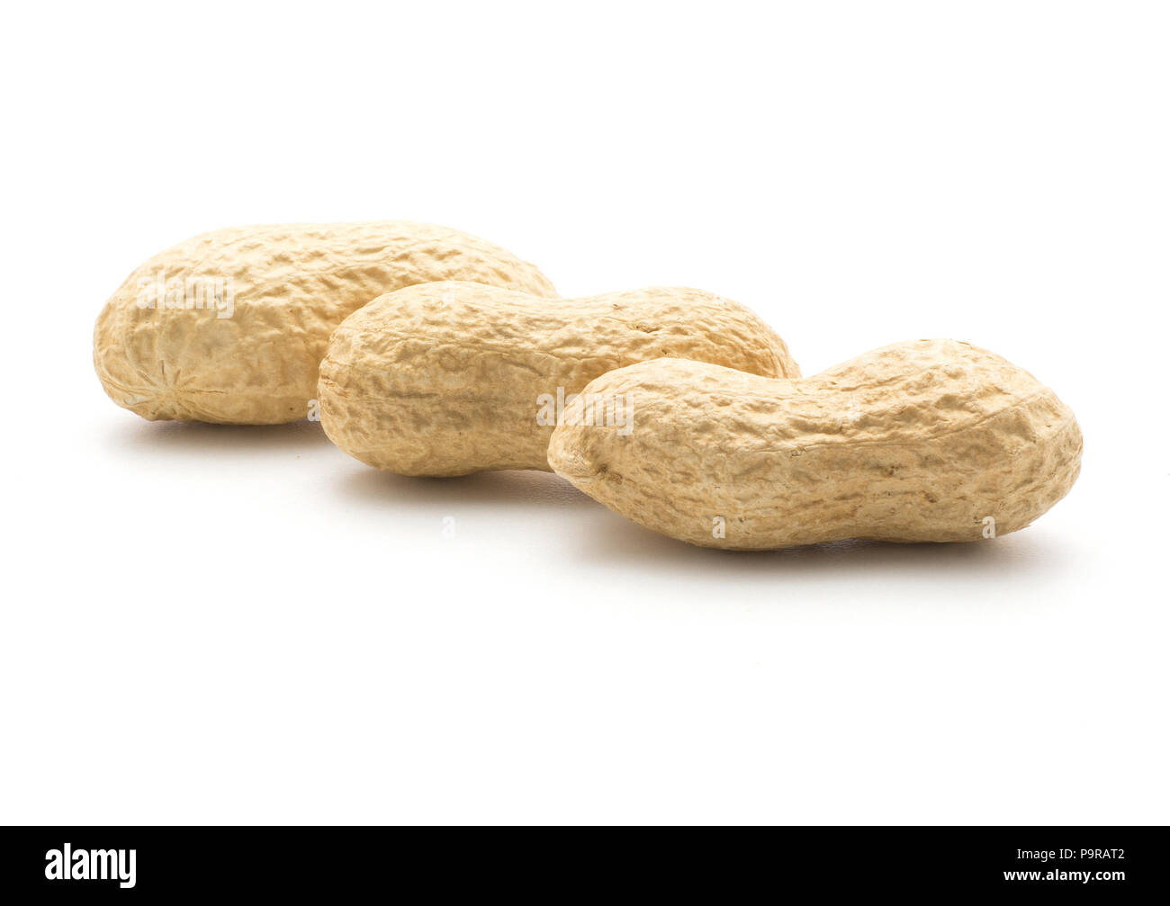 Unshelled peanuts isolated on white background three raw in row Stock ...