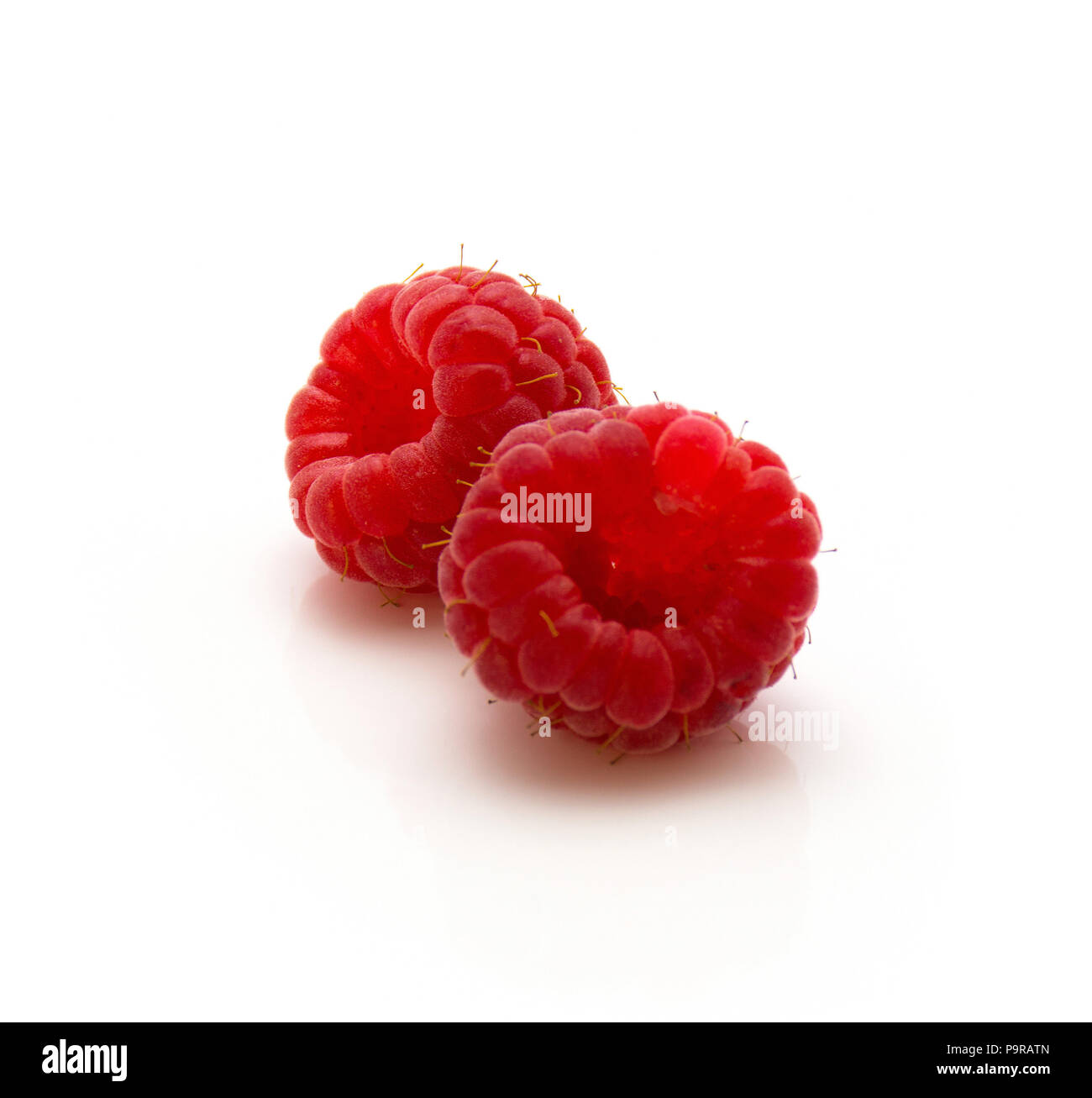 Red raspberries isolated on white background two whole Stock Photo - Alamy