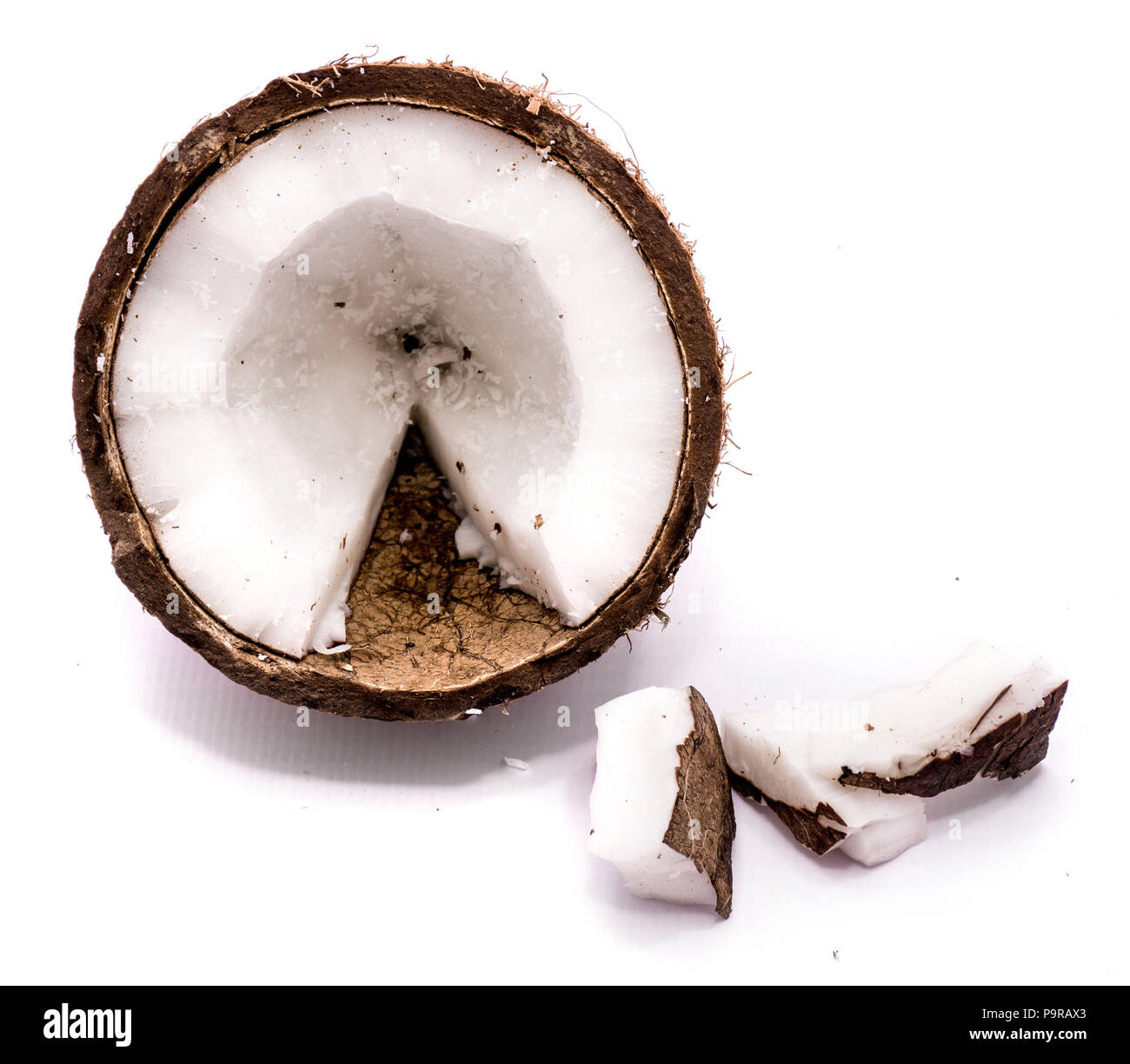 One coconut half and meat pieces isolated on white background Stock ...