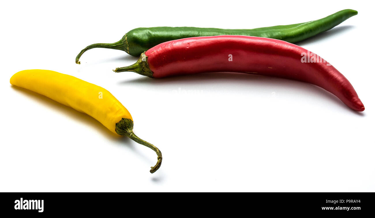 Red, green and yellow Cayenne Chili peppers isolated on white ...