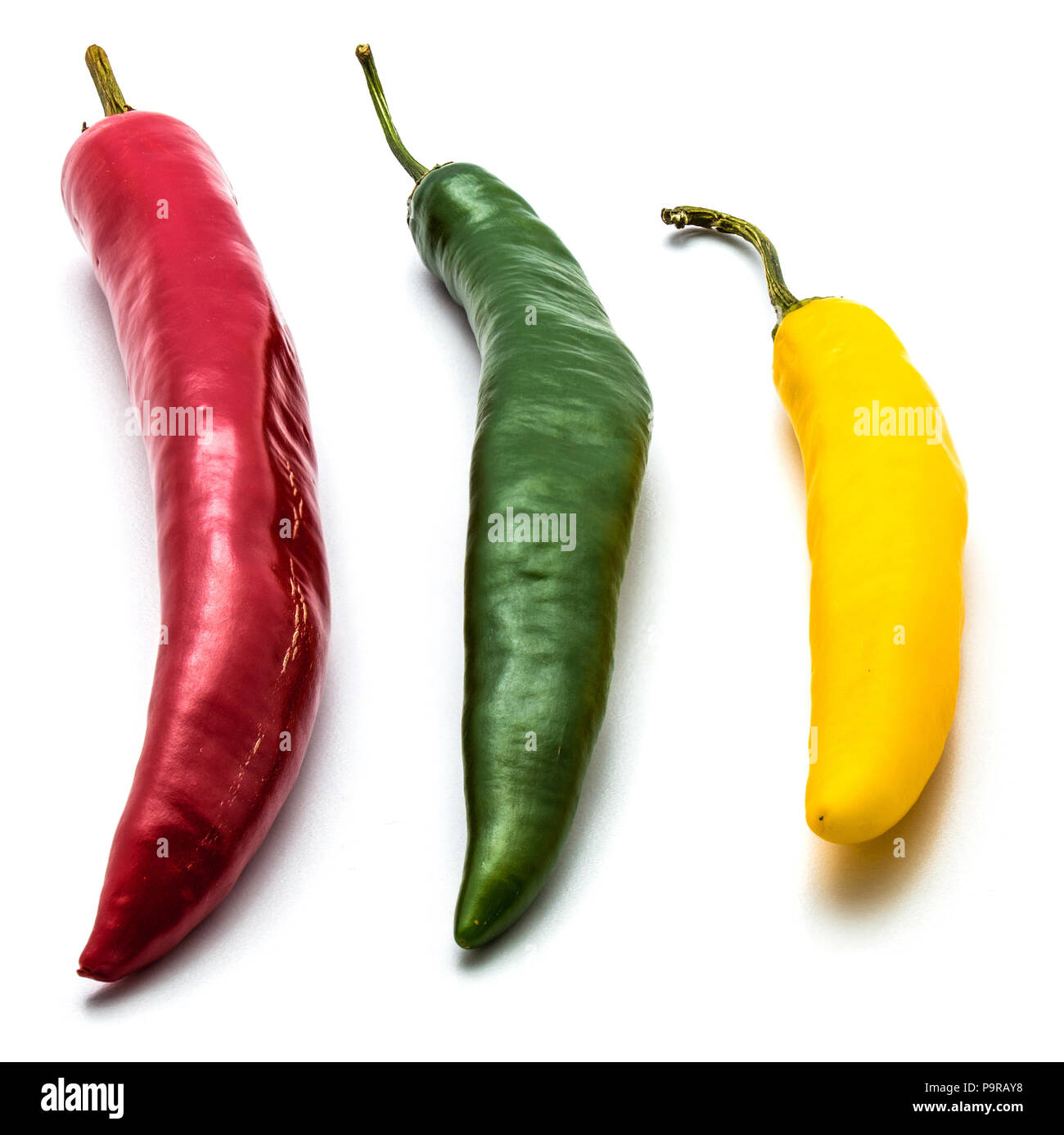 Red, green and yellow Cayenne Chili peppers isolated on white ...
