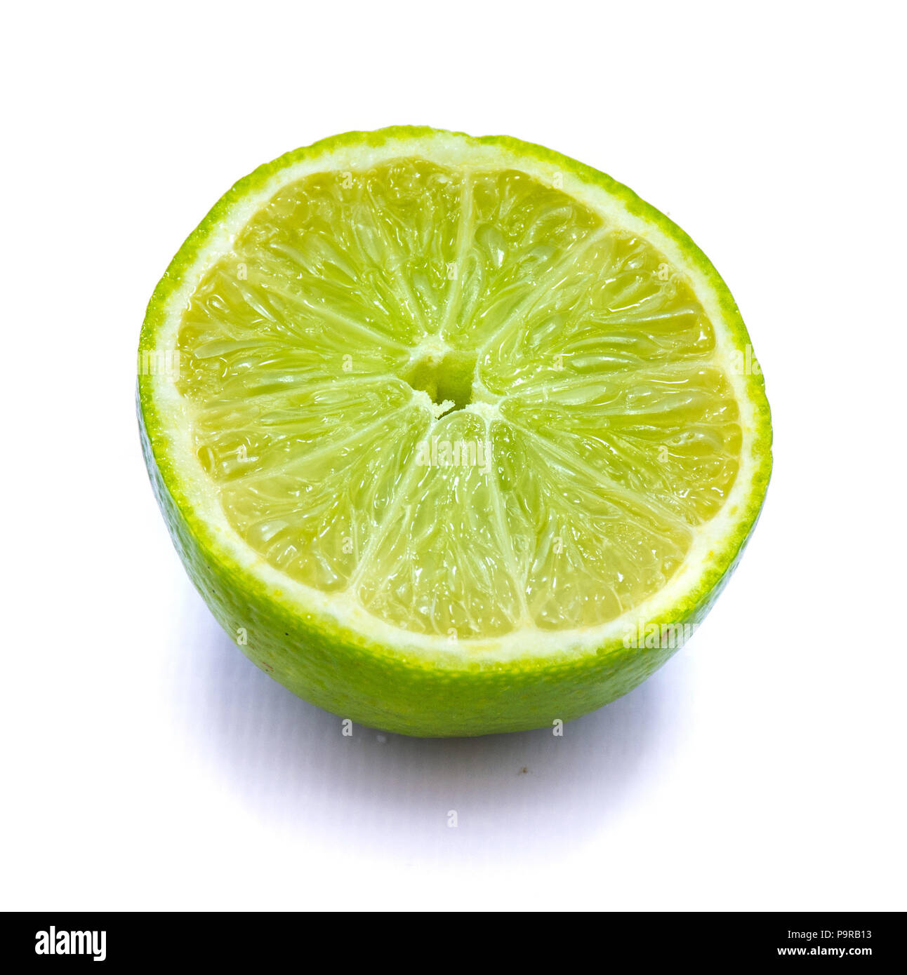 One lime cross section half isolated on white background Stock Photo ...