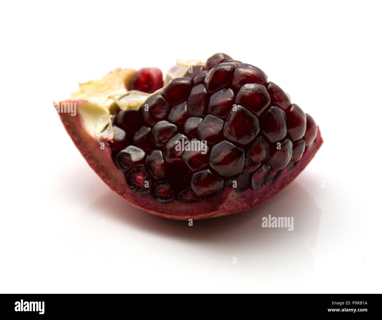Pomegranate isolated on white background split open part with grains ...