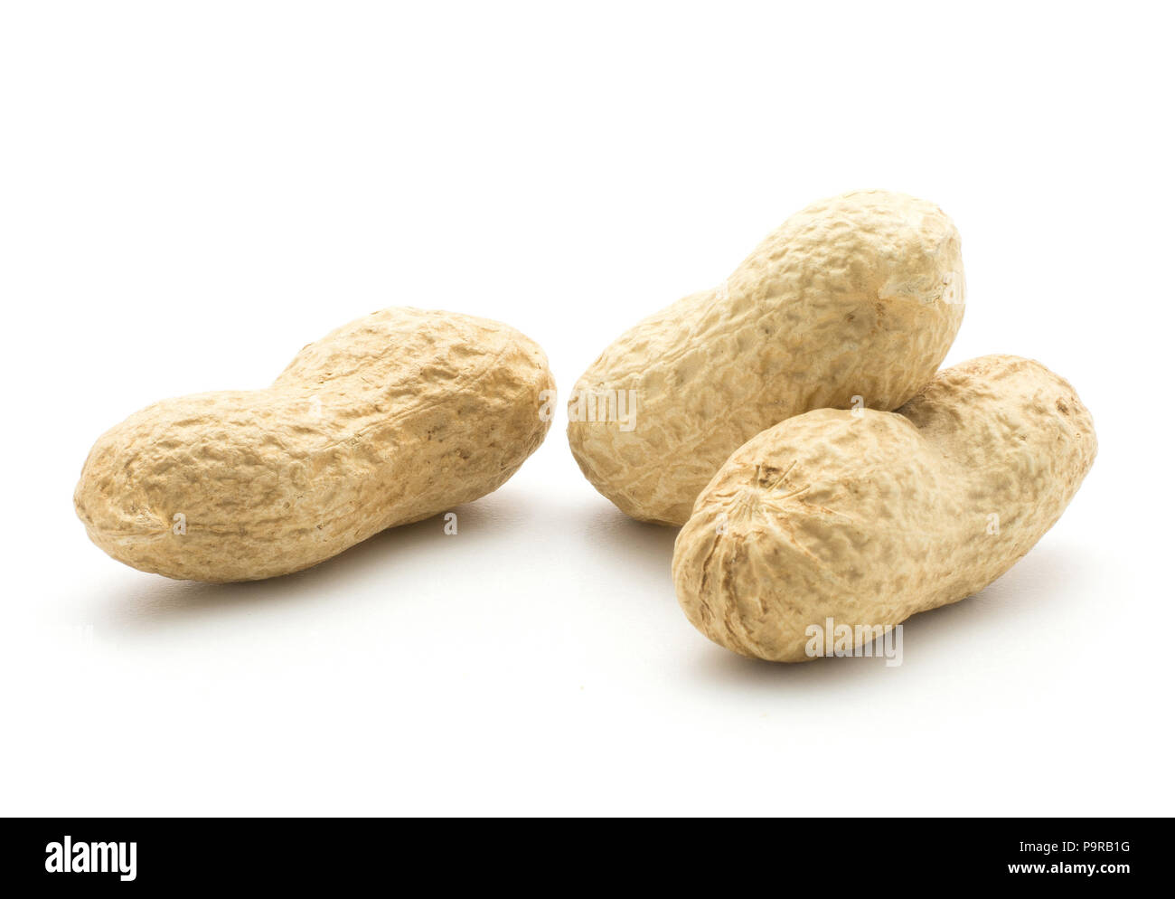 Unshelled peanuts three raw isolated on white background Stock Photo ...