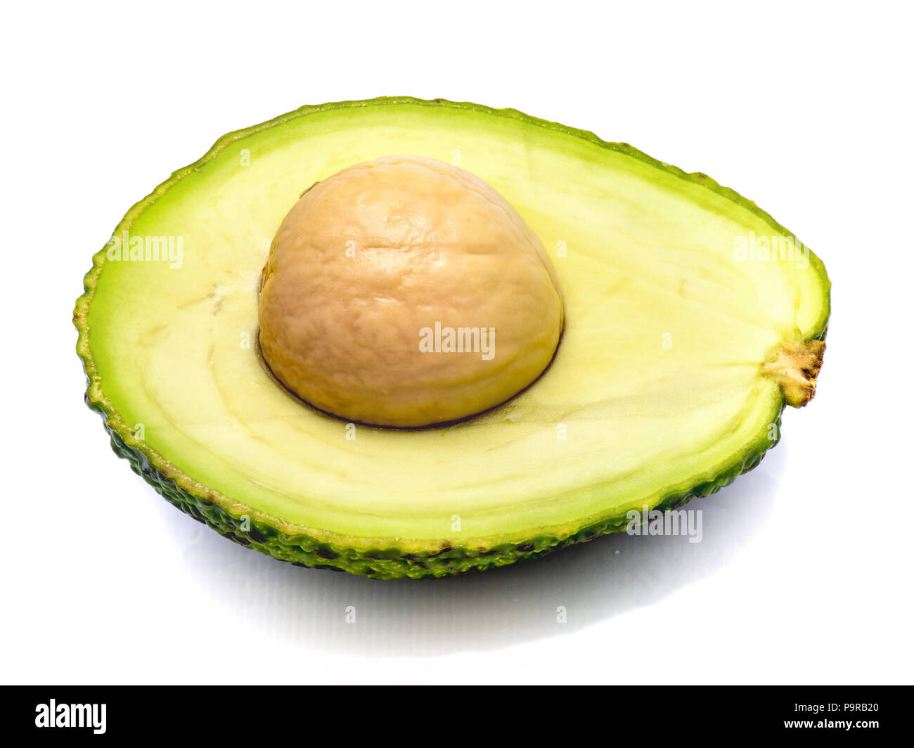 Sliced avocado (Persea americana, alligator pear) with a stone isolated ...