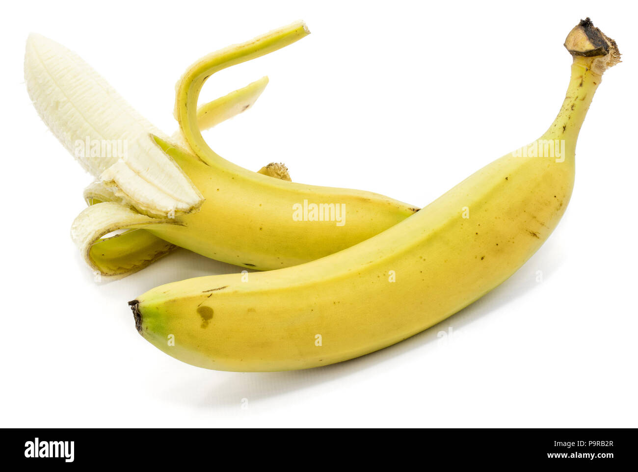 One whole banana, one opened, isolated on white background Stock Photo ...