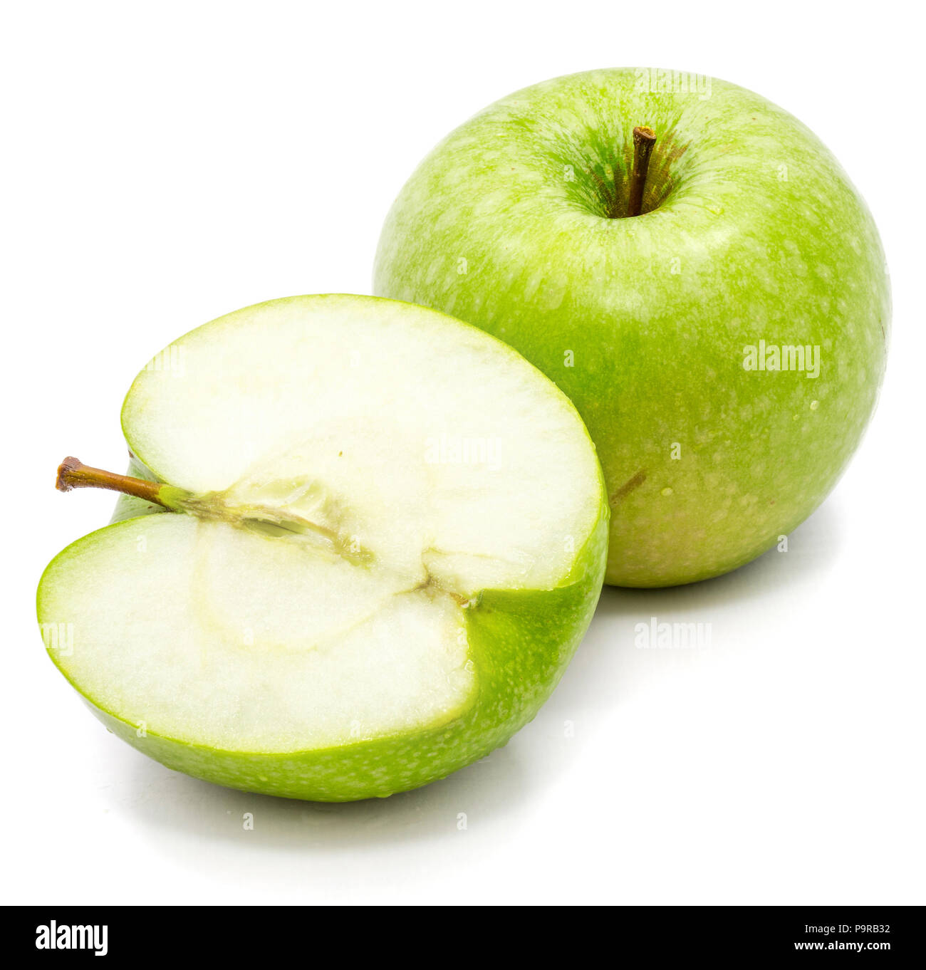 One whole apple Granny Smith and a half isolated on white background ...