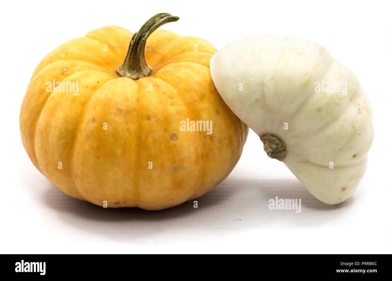 One whole yellow pumpkin, white half isolated on white background Stock ...