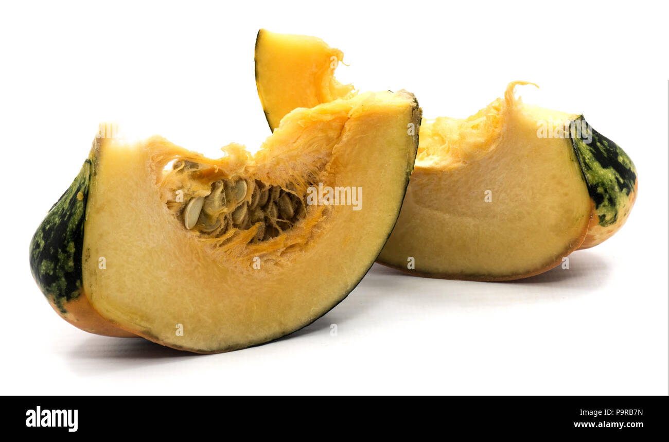 Two spotty green yellow pumpkin slices with seeds isolated on white ...