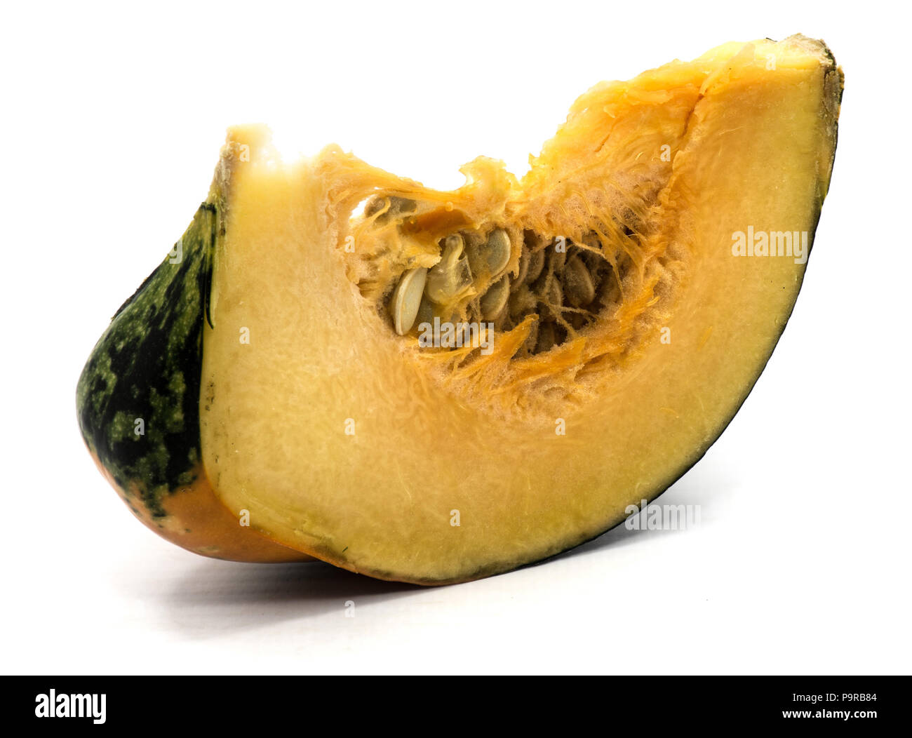 One spotty green yellow pumpkin slice with seeds isolated on white ...