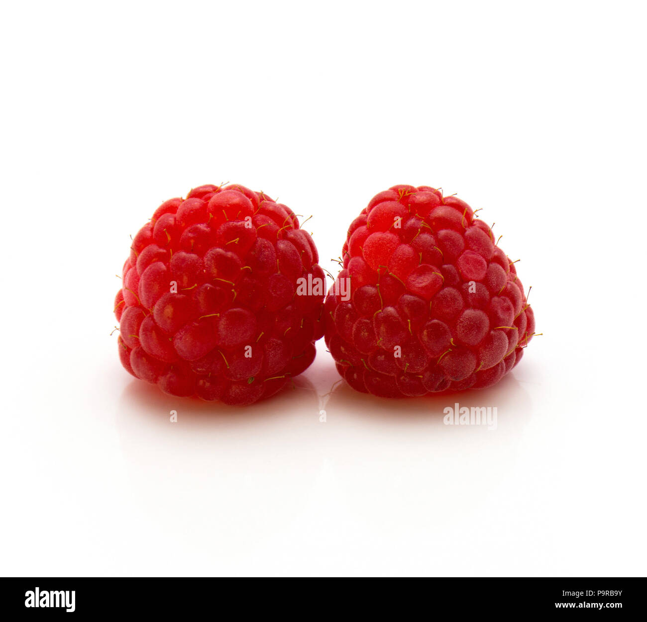 Two red raspberries isolated on white background Stock Photo - Alamy