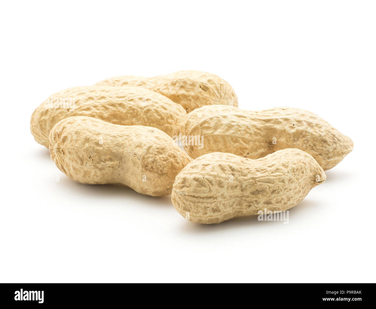 Five unshelled peanuts isolated on white background Stock Photo - Alamy