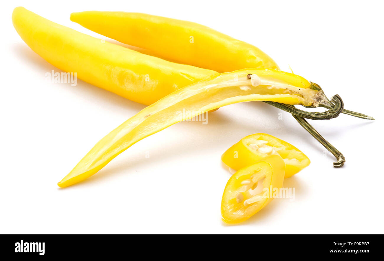 Two whole yellow Chili peppers, one half and two slices, isolated on ...