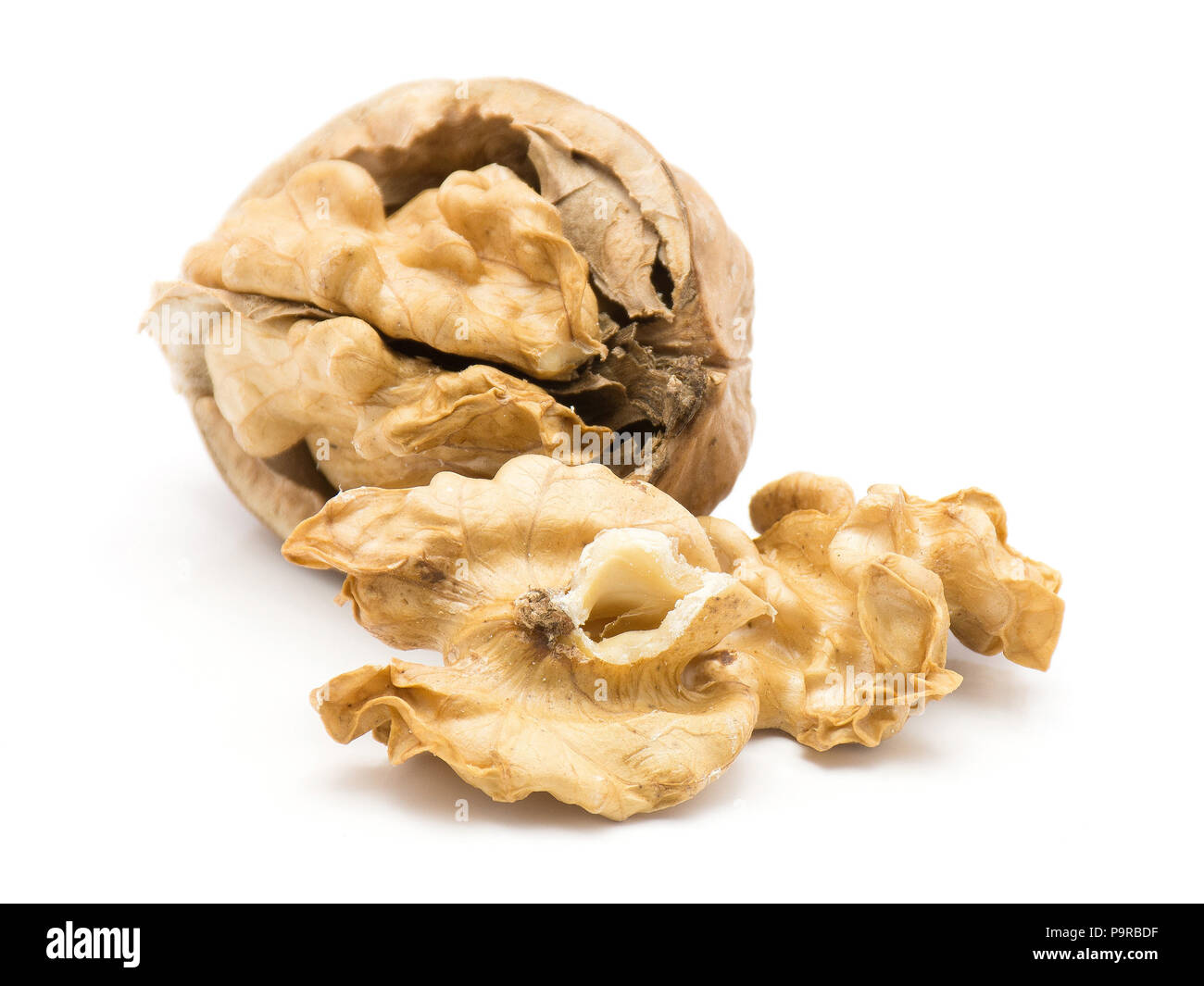 Open walnut half and two shelled nut halves isolated on white ...