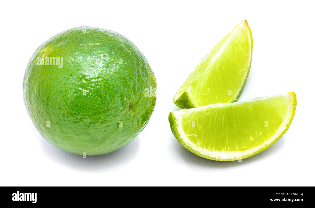 One whole lime and two lime slices isolated on white background Stock ...