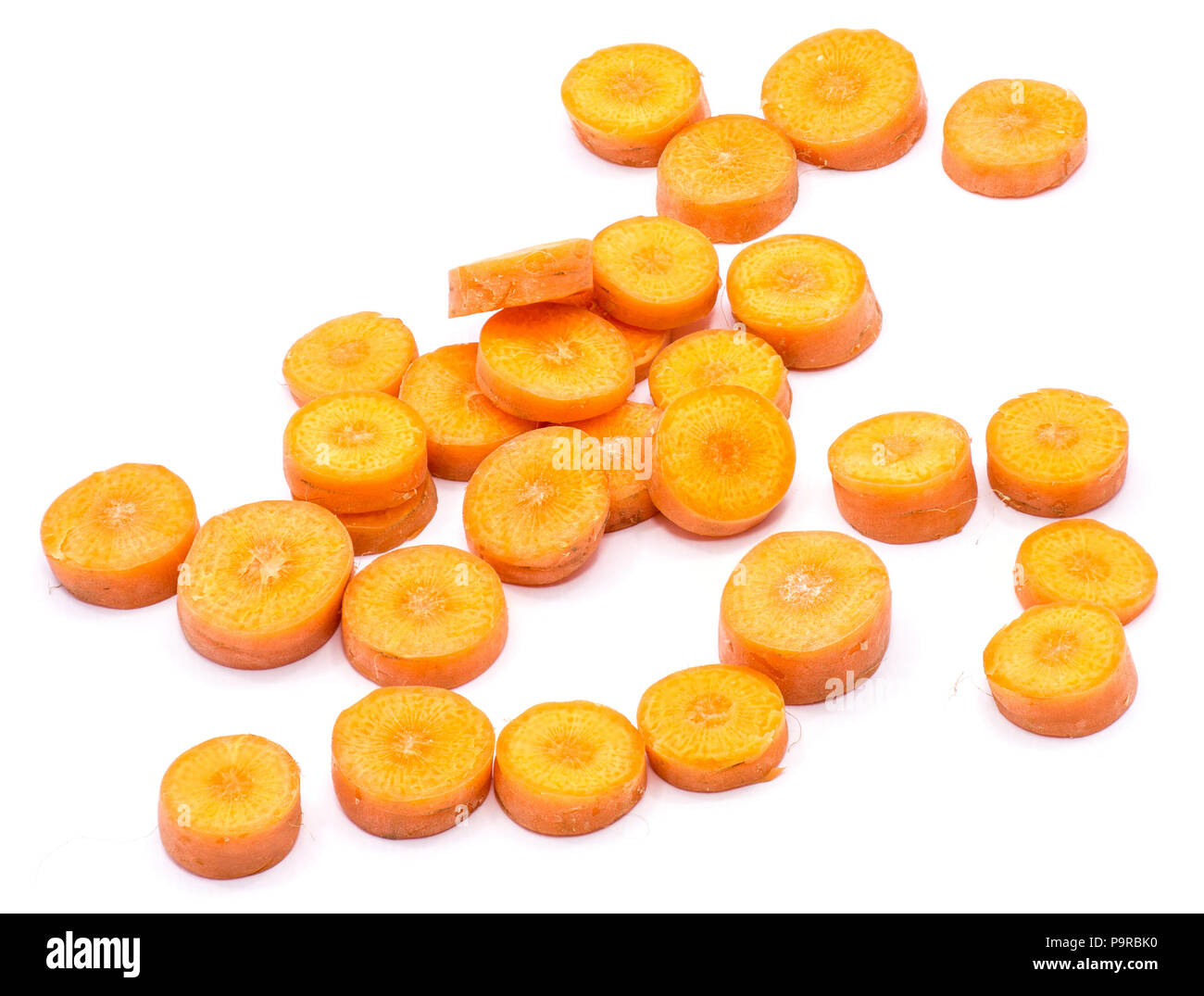 Group of sliced round orange carrot circles in chaos isolated on white ...