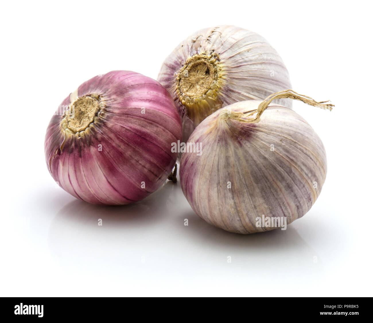 Three whole solo pearl garlic isolated on white background single clove ...