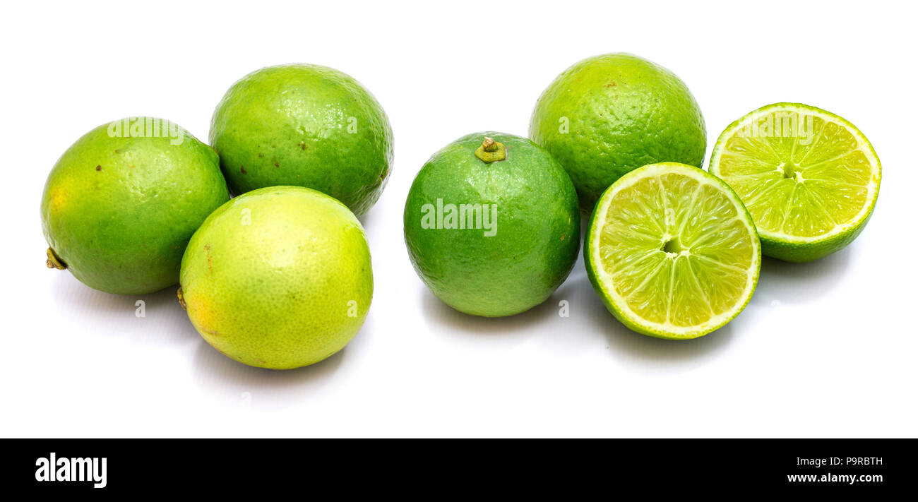 Group of whole and lime halves isolated on white studio background ...